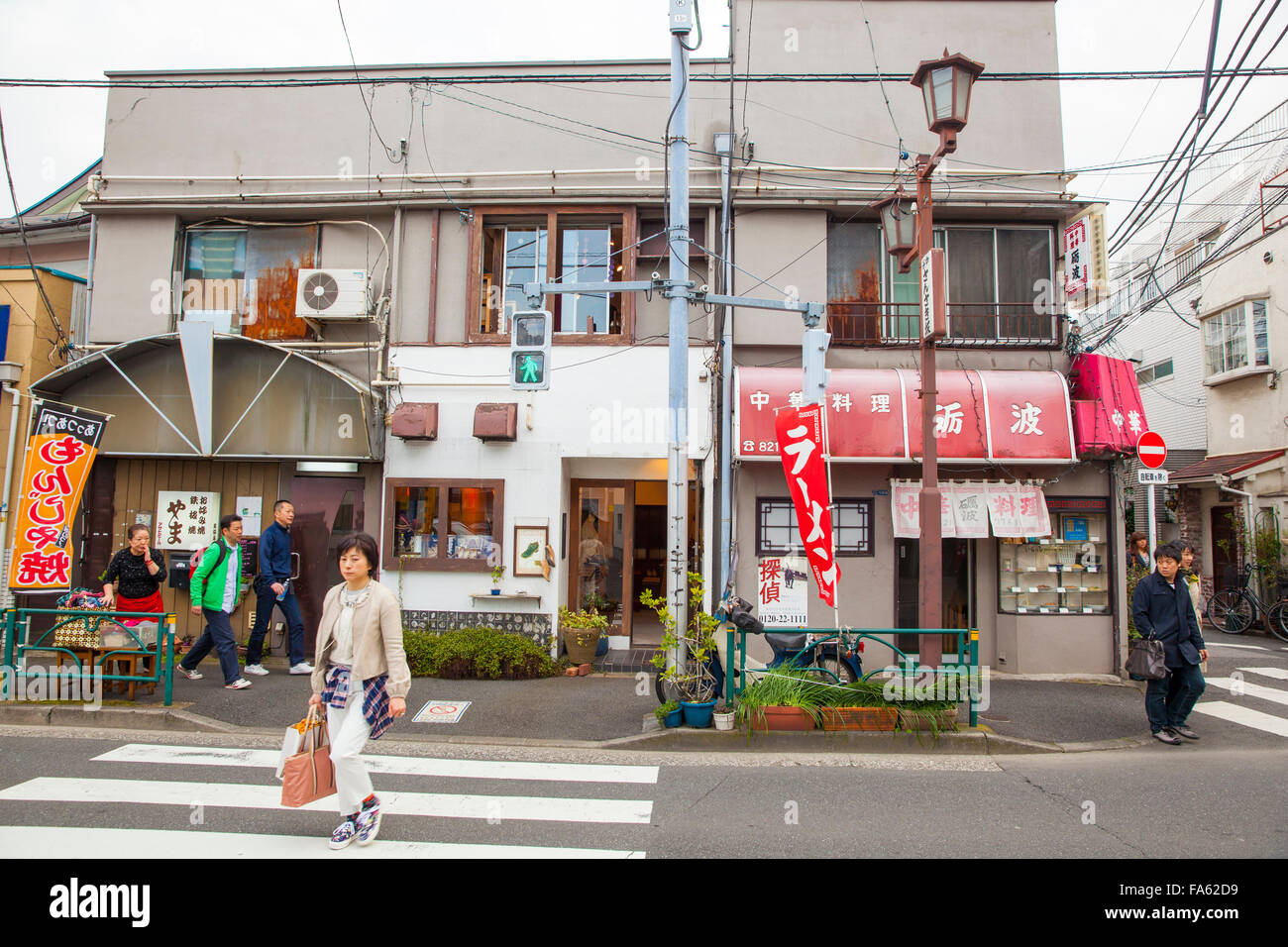 A street life picture of a Japanese woman crossing the doad Stock Photo ...