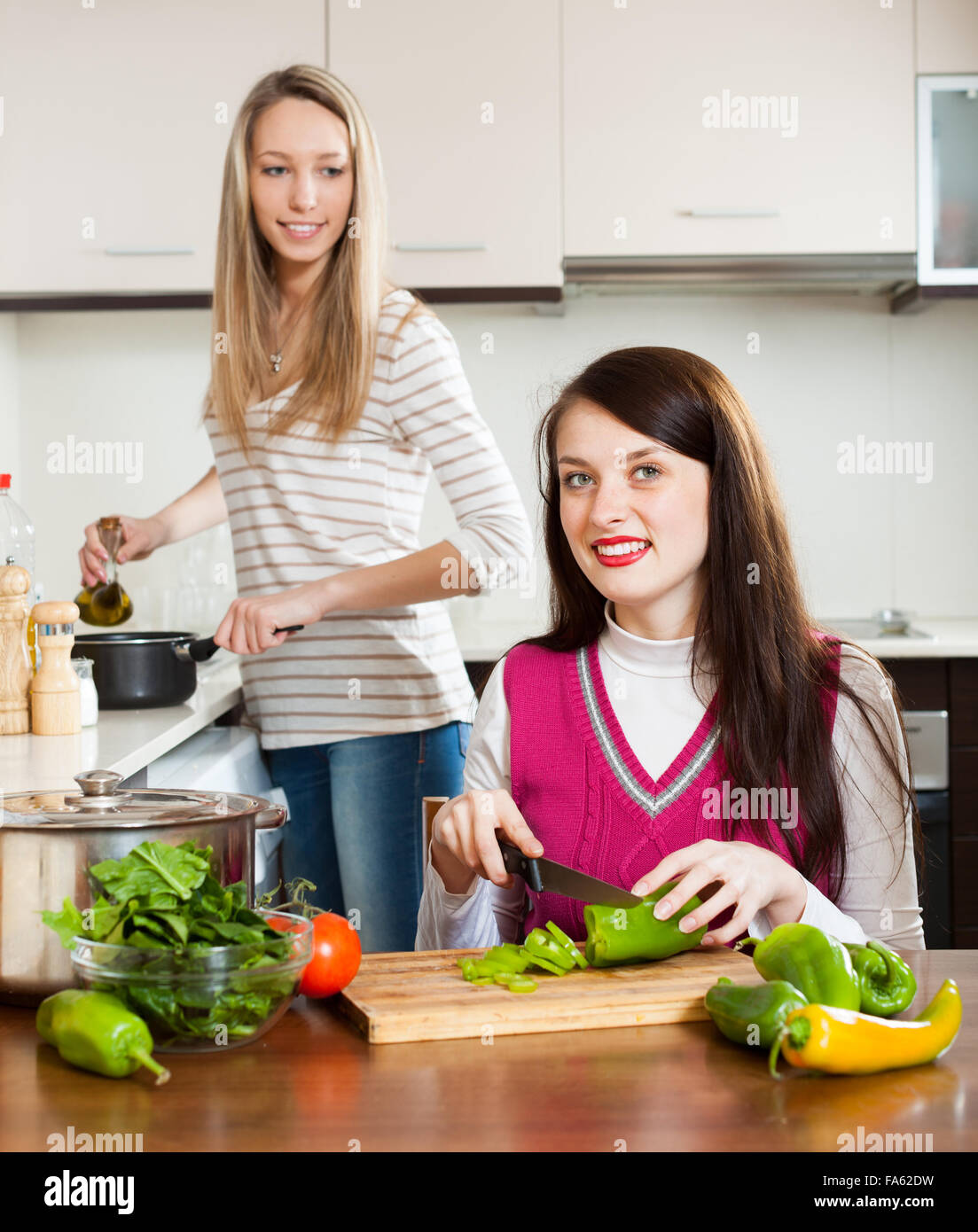 ordinary smiling women cooking in kitchen at home Stock Photo - Alamy