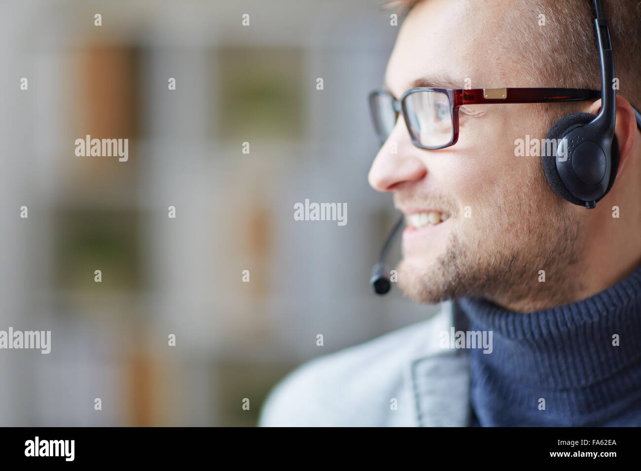 Modern young operator with headphones and mike Stock Photo - Alamy