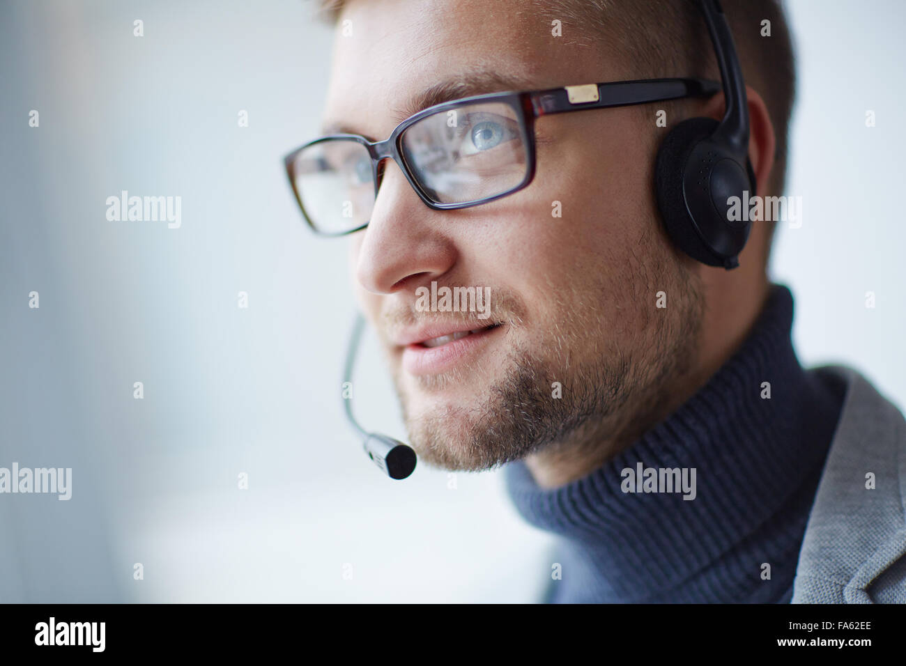 Handsome operator with headphones and mike working online Stock Photo ...