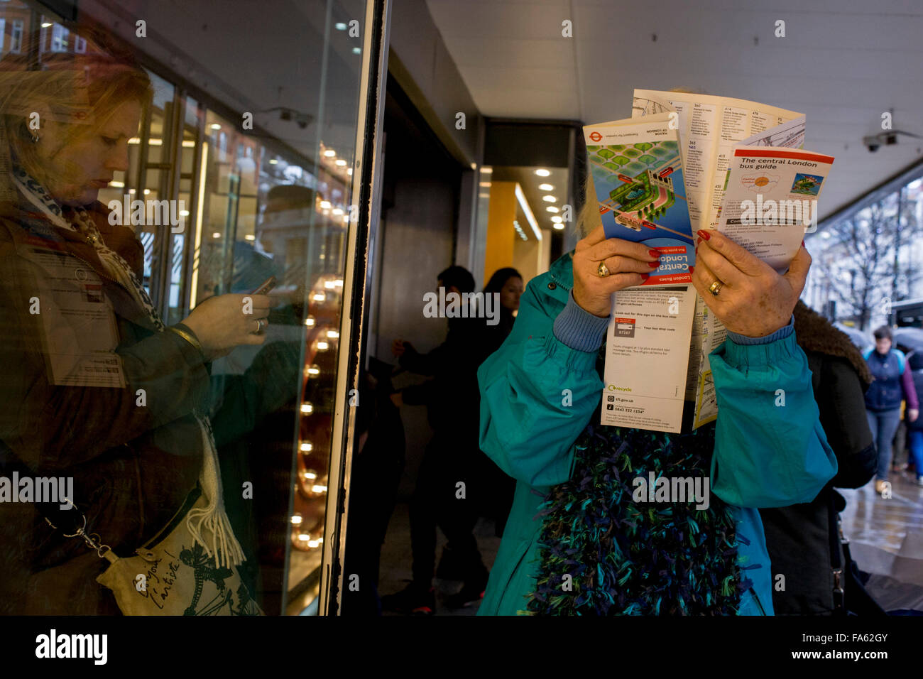 A Poor sighted Shopper Examines Close up A Map Of Central London While Shopping In Oxford Street a-poor-sighted-shopper-examines-close-up-a-map-of-central-london-while-shopping-in-oxford-street