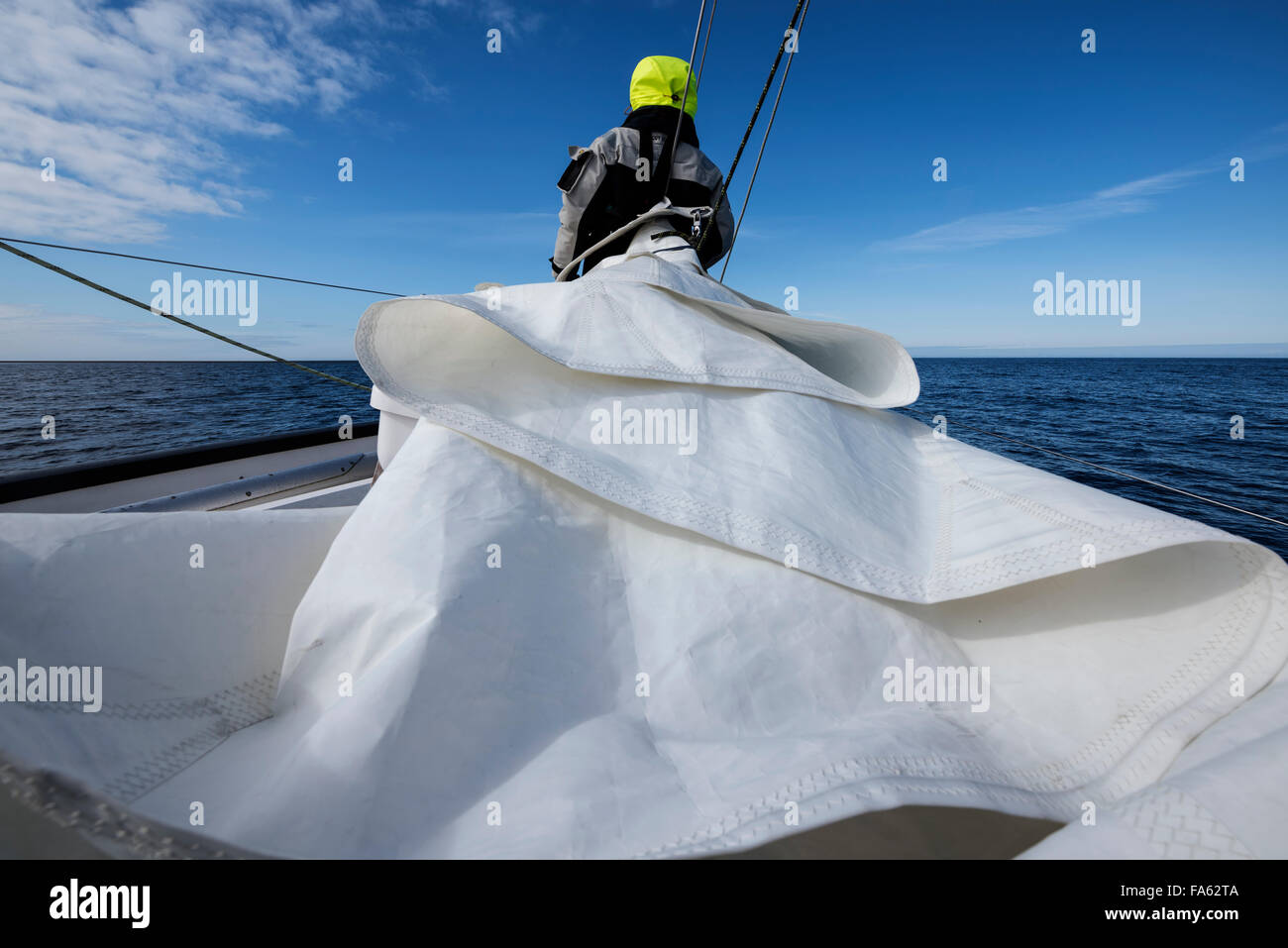Person standing watch on front of sailboat Stock Photo - Alamy