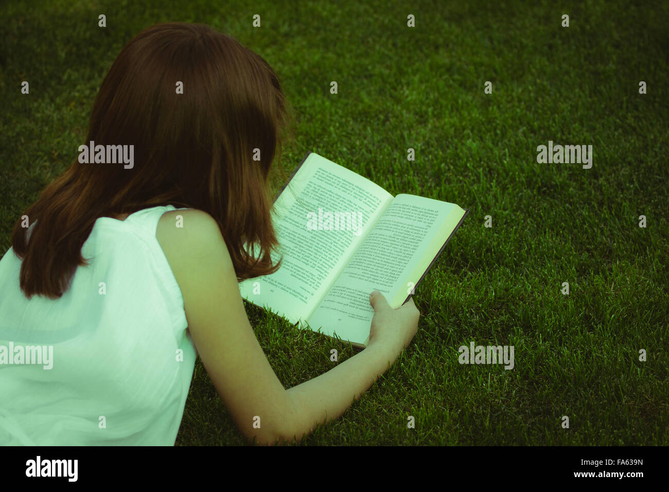 Student.Young beautiful girl reading a book outdoor Stock Photo - Alamy