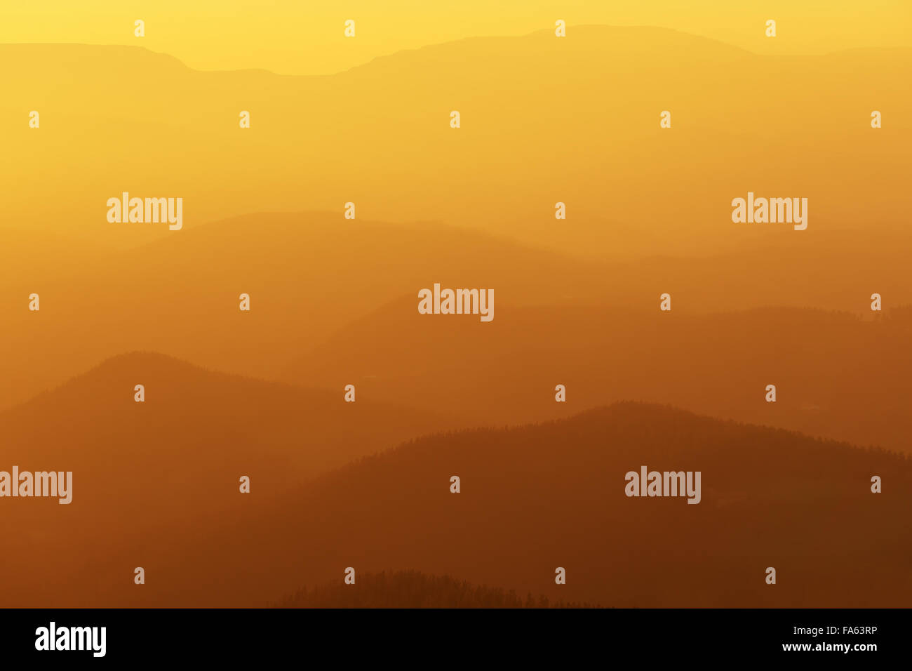 distant mountains at the sunset with warm colors Stock Photo - Alamy