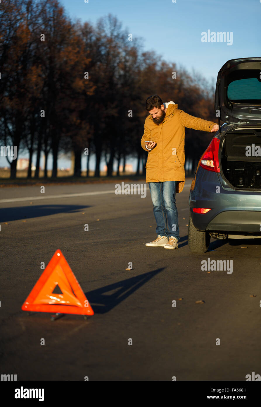 Driver man examining damaged automobile cars after breaking Stock Photo ...