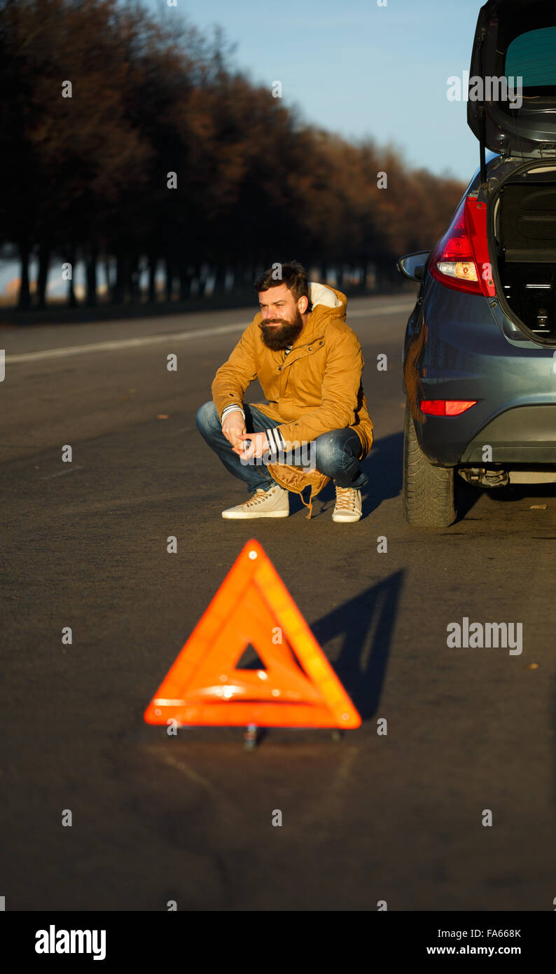 Driver man examining damaged automobile cars after breaking Stock Photo ...