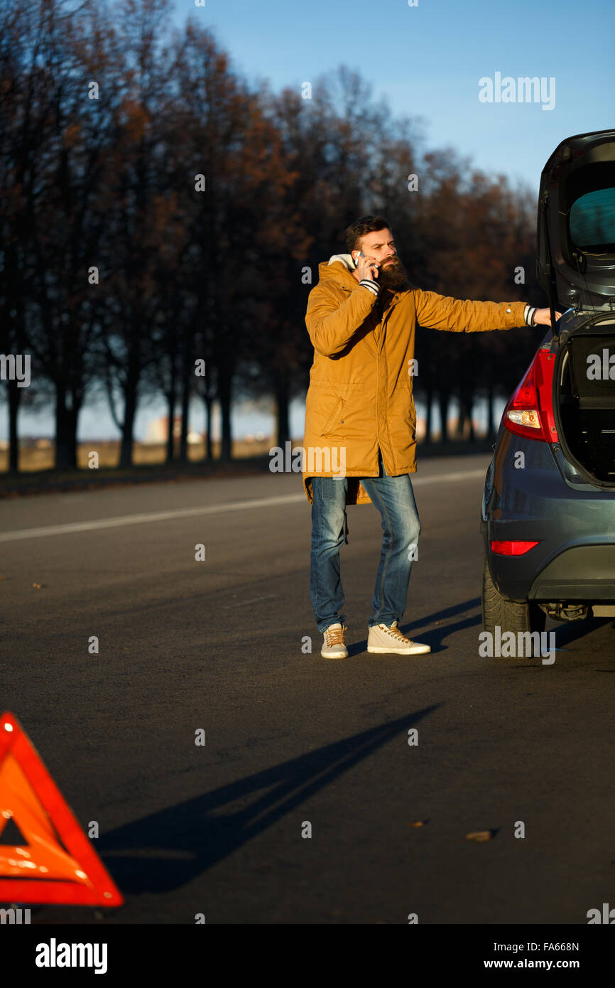 Driver man examining damaged automobile cars after breaking Stock Photo ...