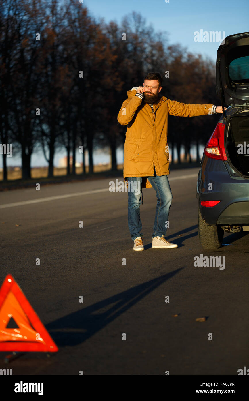 Driver man examining damaged automobile cars after breaking Stock Photo ...