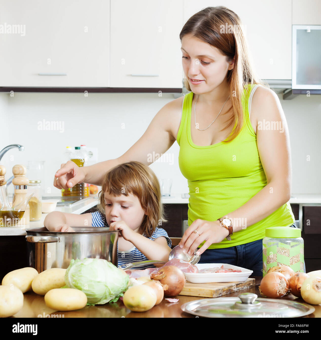 woman with child making soup from meat and vegetables Stock Photo - Alamy