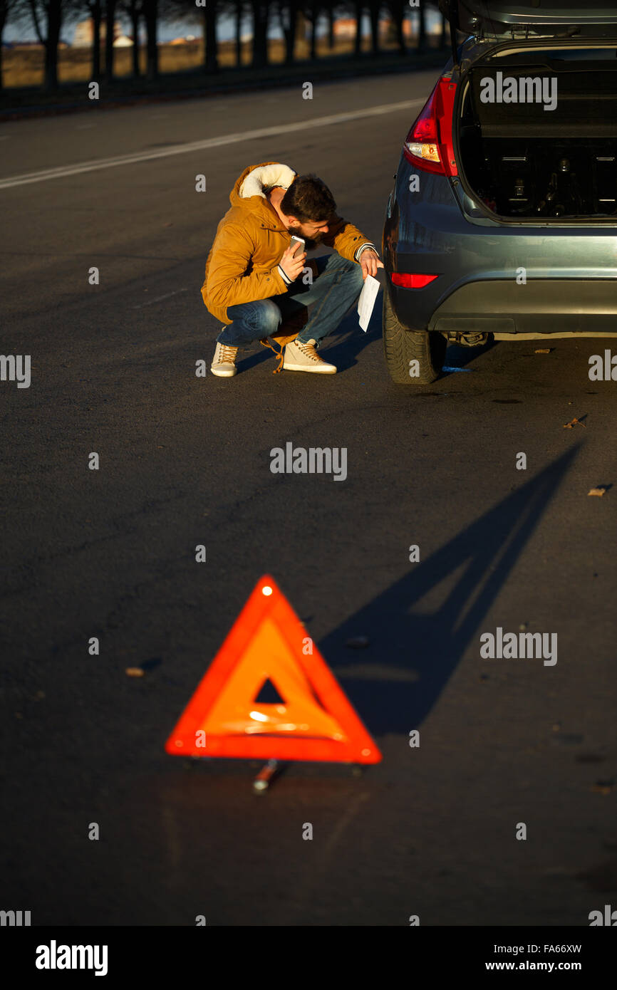 Driver man examining damaged automobile cars after breaking Stock Photo ...