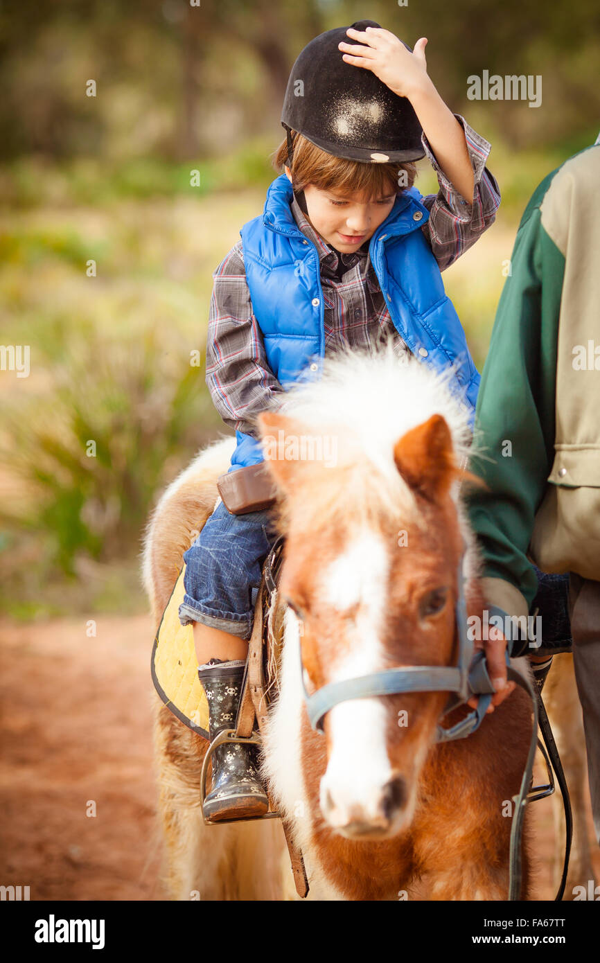 Portrait of a boy riding pony horse Stock Photo - Alamy