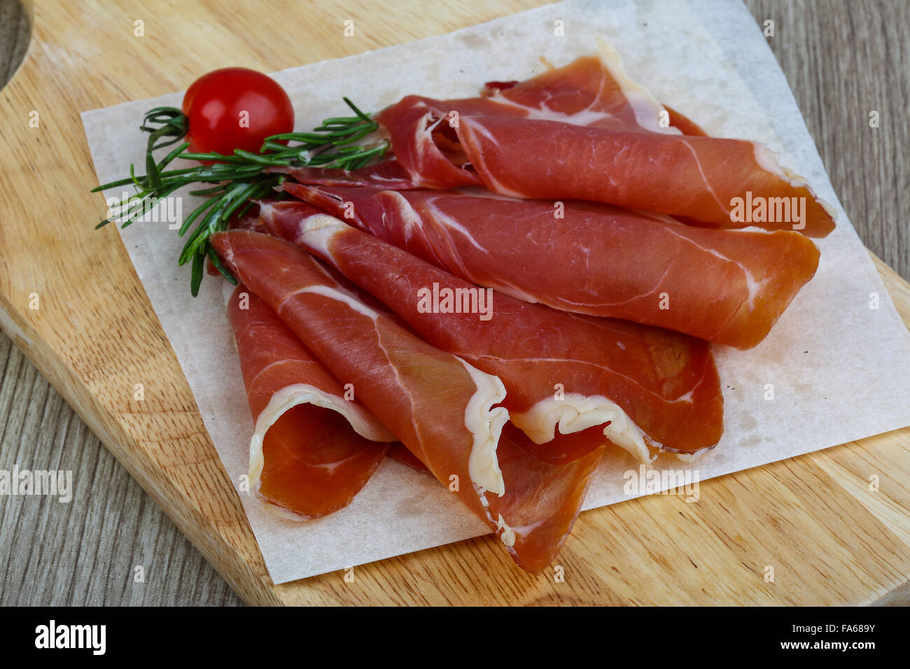 Spanish traditional snack - Jamon with tomato and rosemary Stock Photo ...