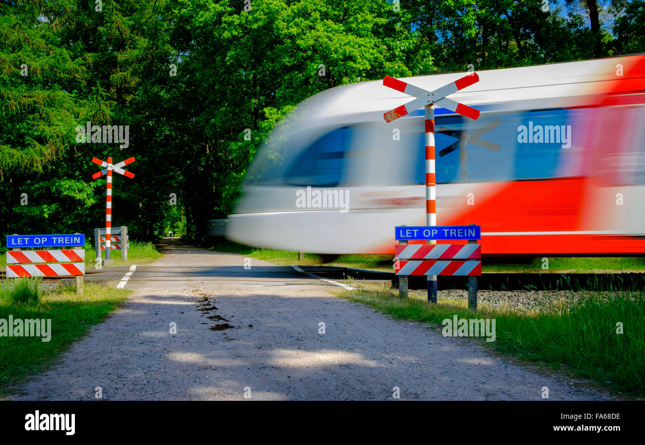 Train driving across road crossing, Gelderland, Netherlands Stock Photo ...
