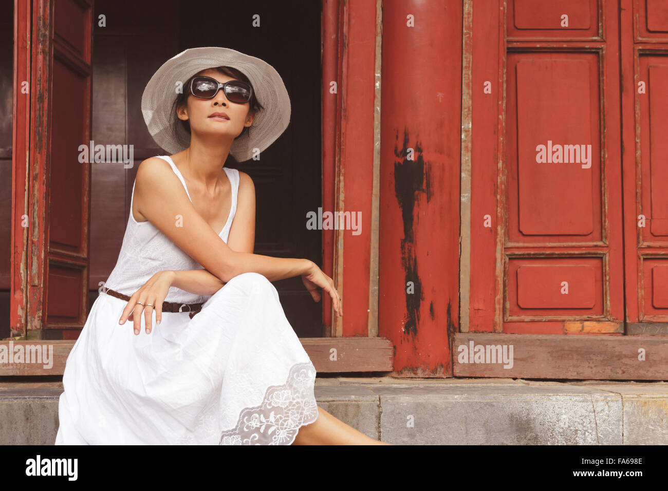 Woman sitting on a step Stock Photo - Alamy