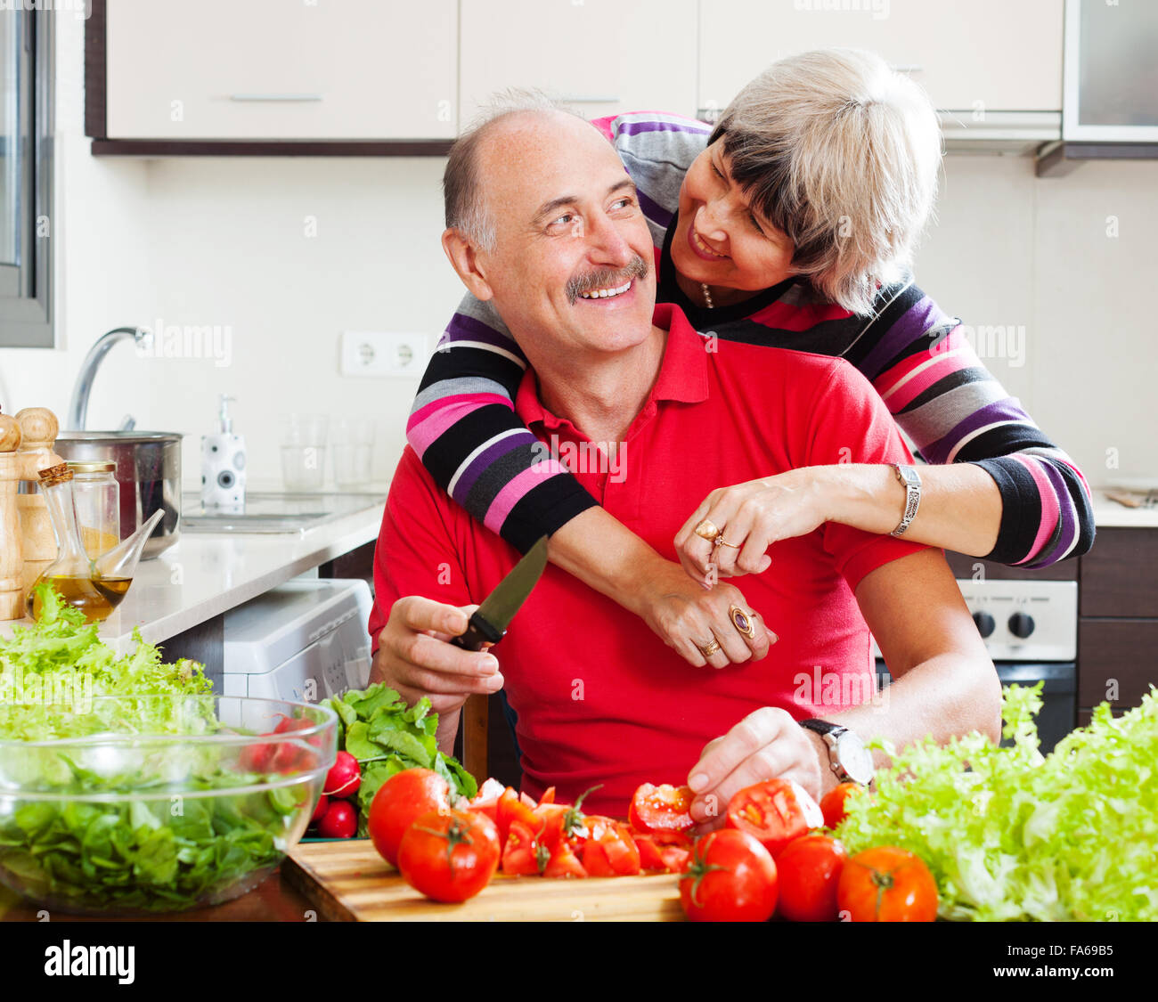 Loving mature couple cooking together Stock Photo - Alamy