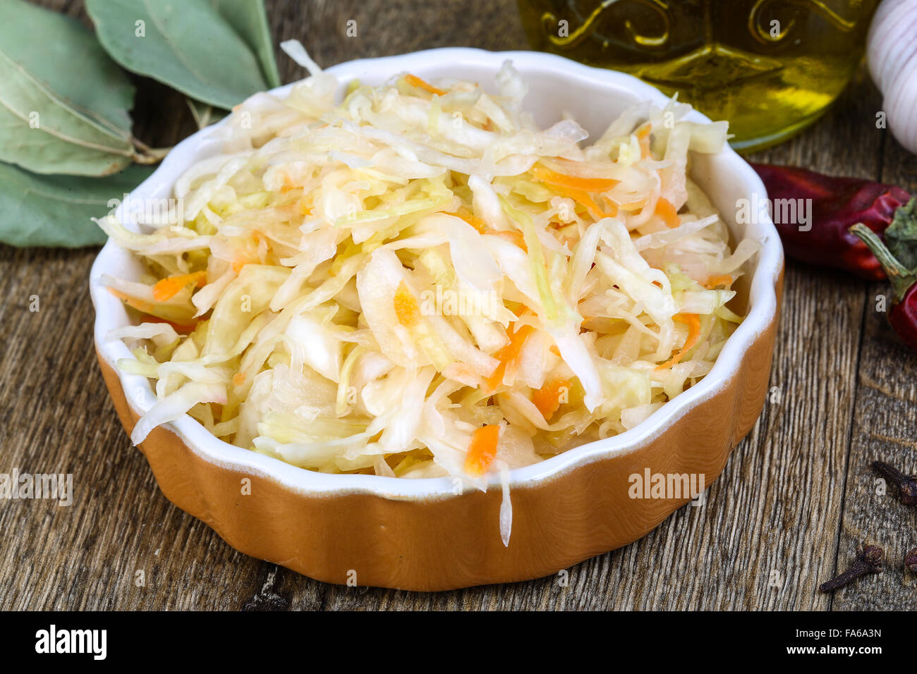 Fermented cabbage - Sauerkraut with herbs and spices on the wood ...