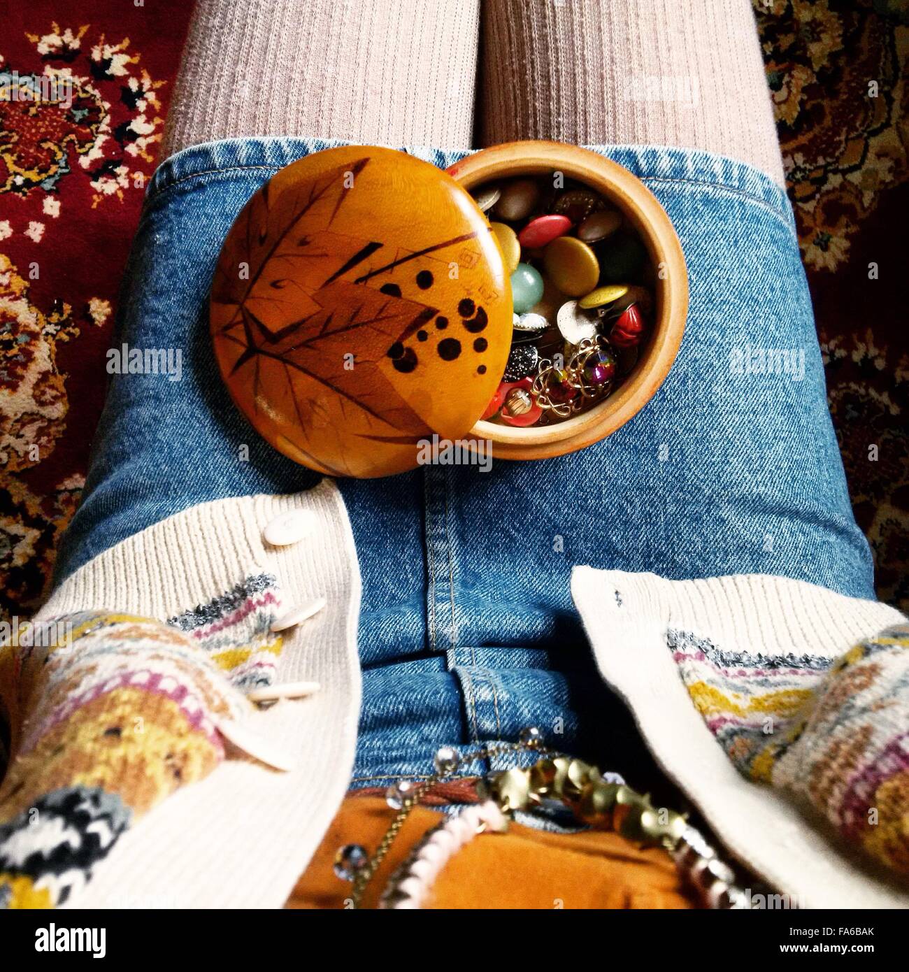 Overhead view of girl sitting with jewelry box on her lap Stock Photo ...