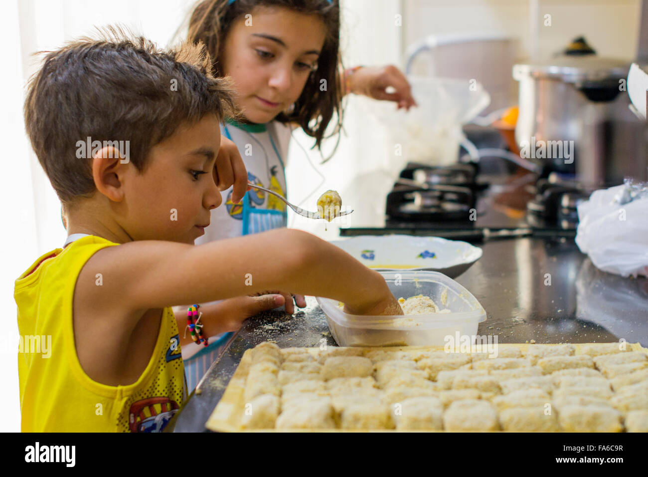 Boy and girl making croquettes in the kitchen Stock Photo - Alamy