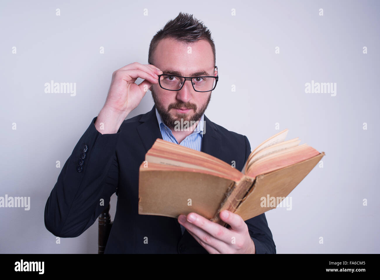 Man sitting reading a book Stock Photo - Alamy