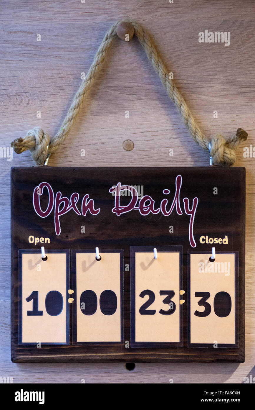 Open Daily sign hanging on wall Stock Photo - Alamy