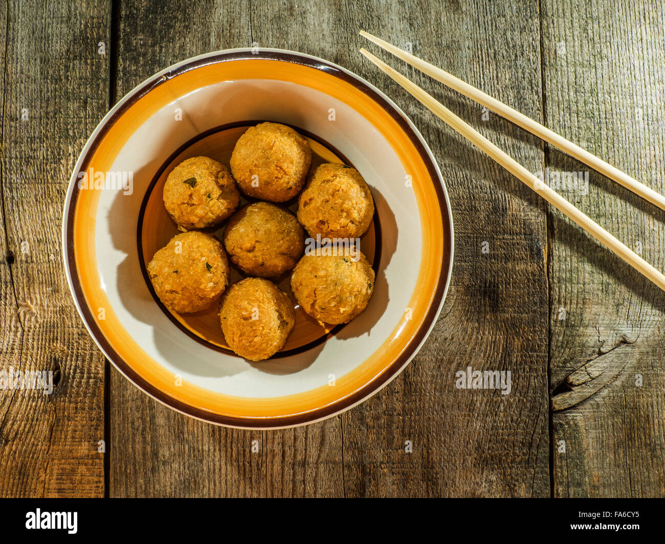 Soya balls in a bowl with chopsticks Stock Photo - Alamy