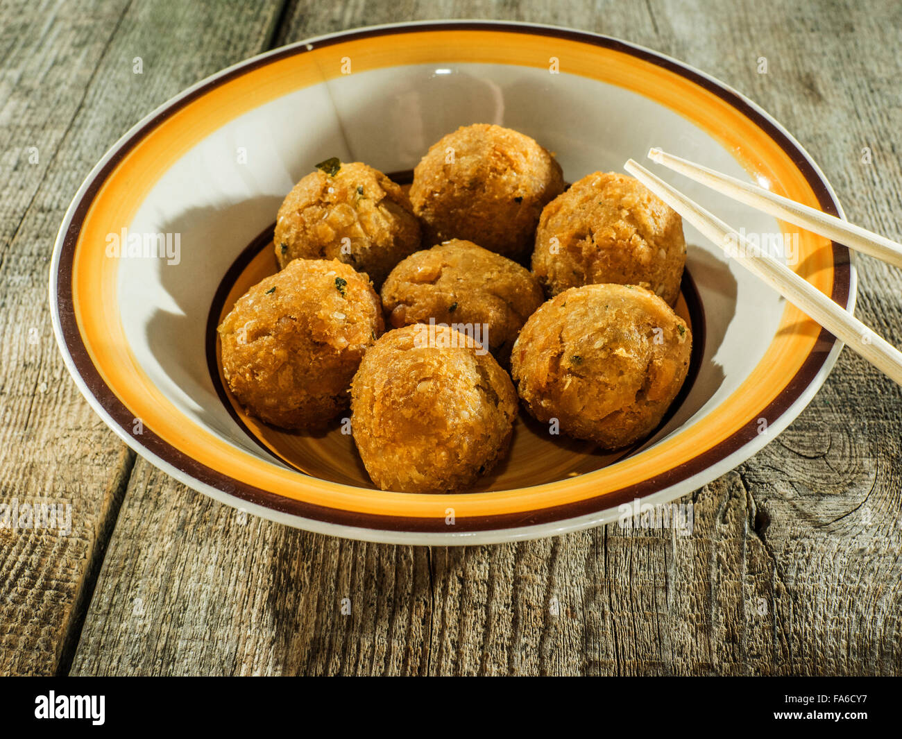 Soya balls in a bowl with chopsticks Stock Photo - Alamy