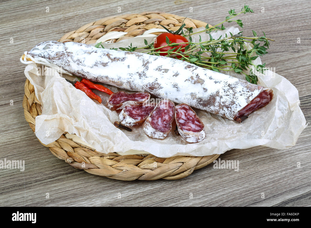 Traditional Spanish sausages- fuet with thyme leaves on the wood ...
