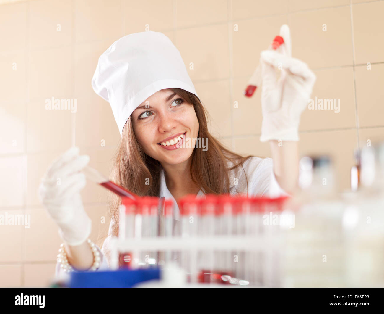 Young nurse works with blood sample in medical laboratory Stock Photo ...