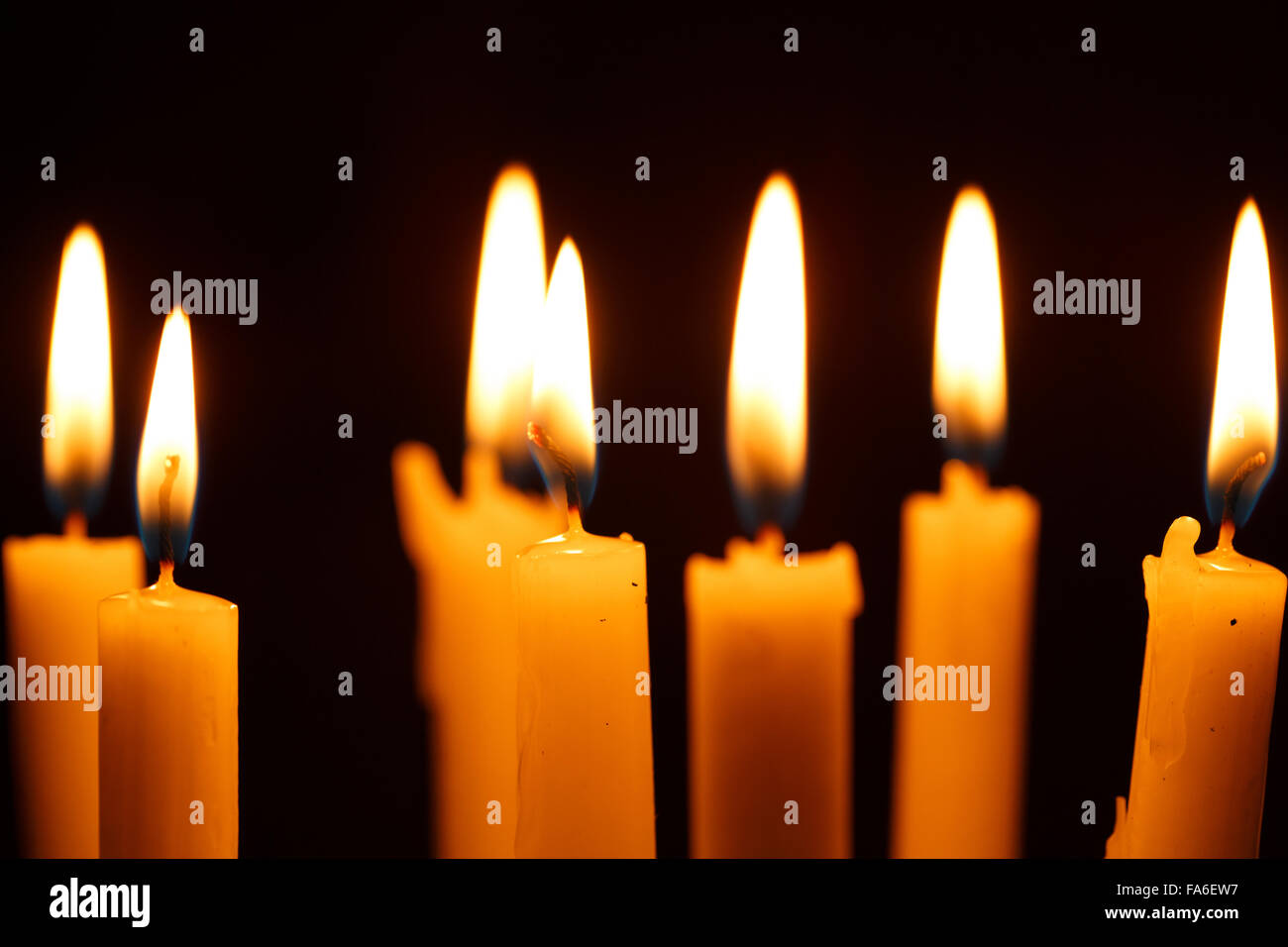 Many burning candles on black background Stock Photo - Alamy