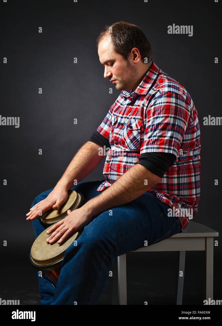 portrait of musician with bongo , studio shot Stock Photo - Alamy