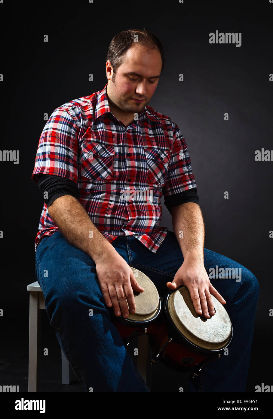 portrait of musician with bongo , studio shot Stock Photo - Alamy