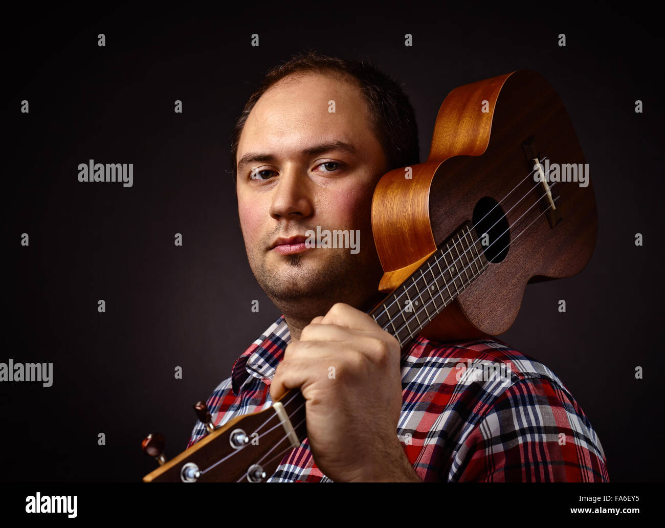 portrait of musician with ukulele , studio shot Stock Photo - Alamy