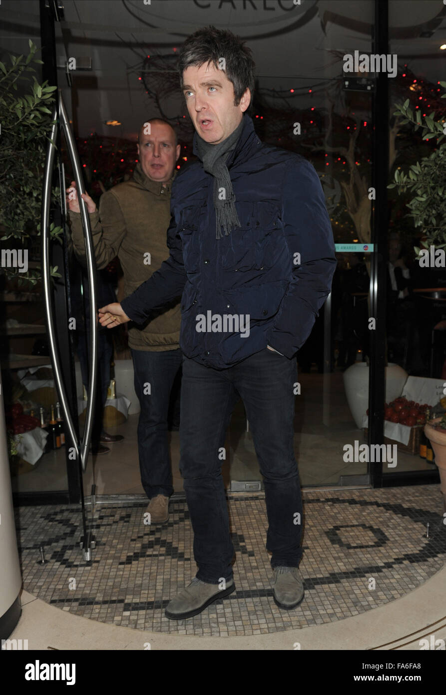 Noel Gallagher hands a 20 pound note to a homeless man as he and his ...