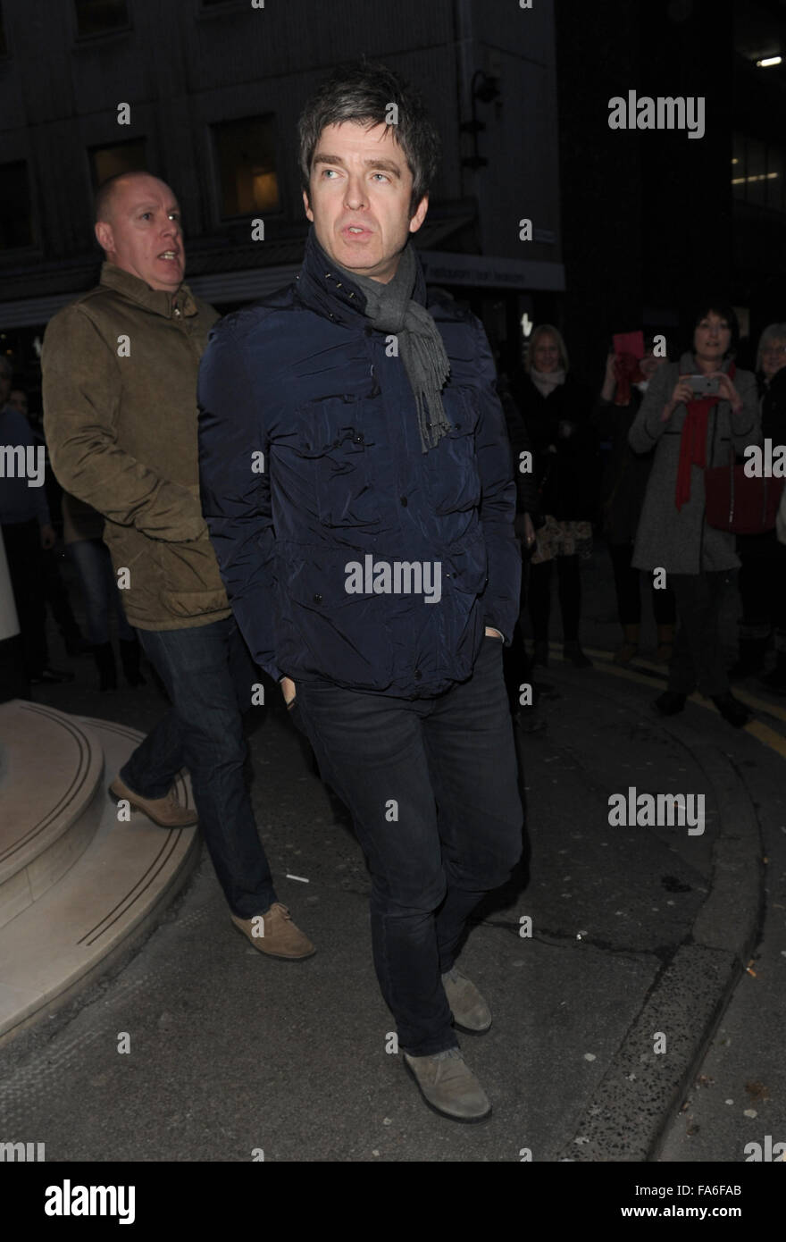Noel Gallagher hands a 20 pound note to a homeless man as he and his ...