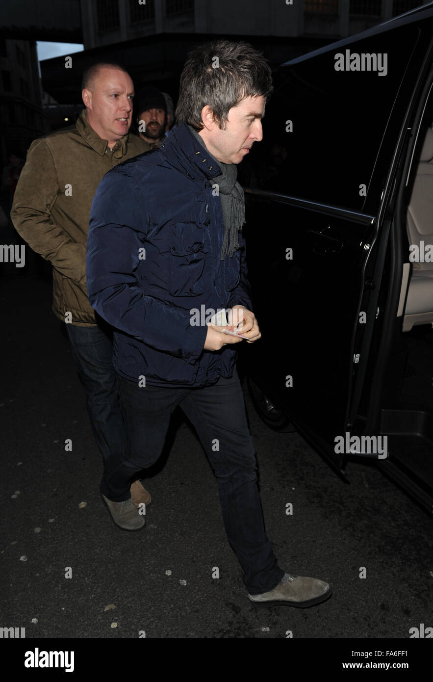 Noel Gallagher hands a 20 pound note to a homeless man as he and his ...