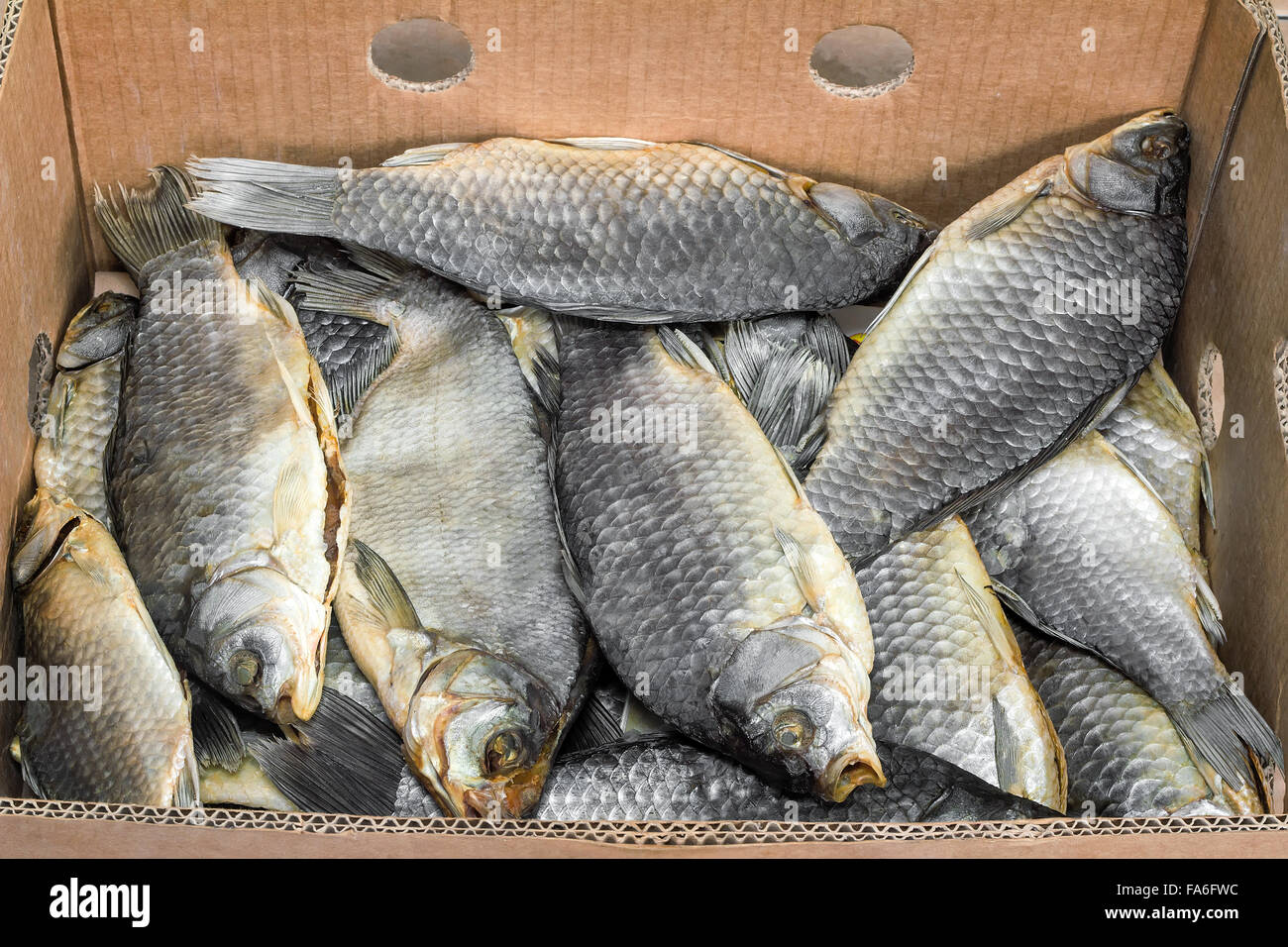 In a large cardboard box is a lot of salted and dried in large river ...