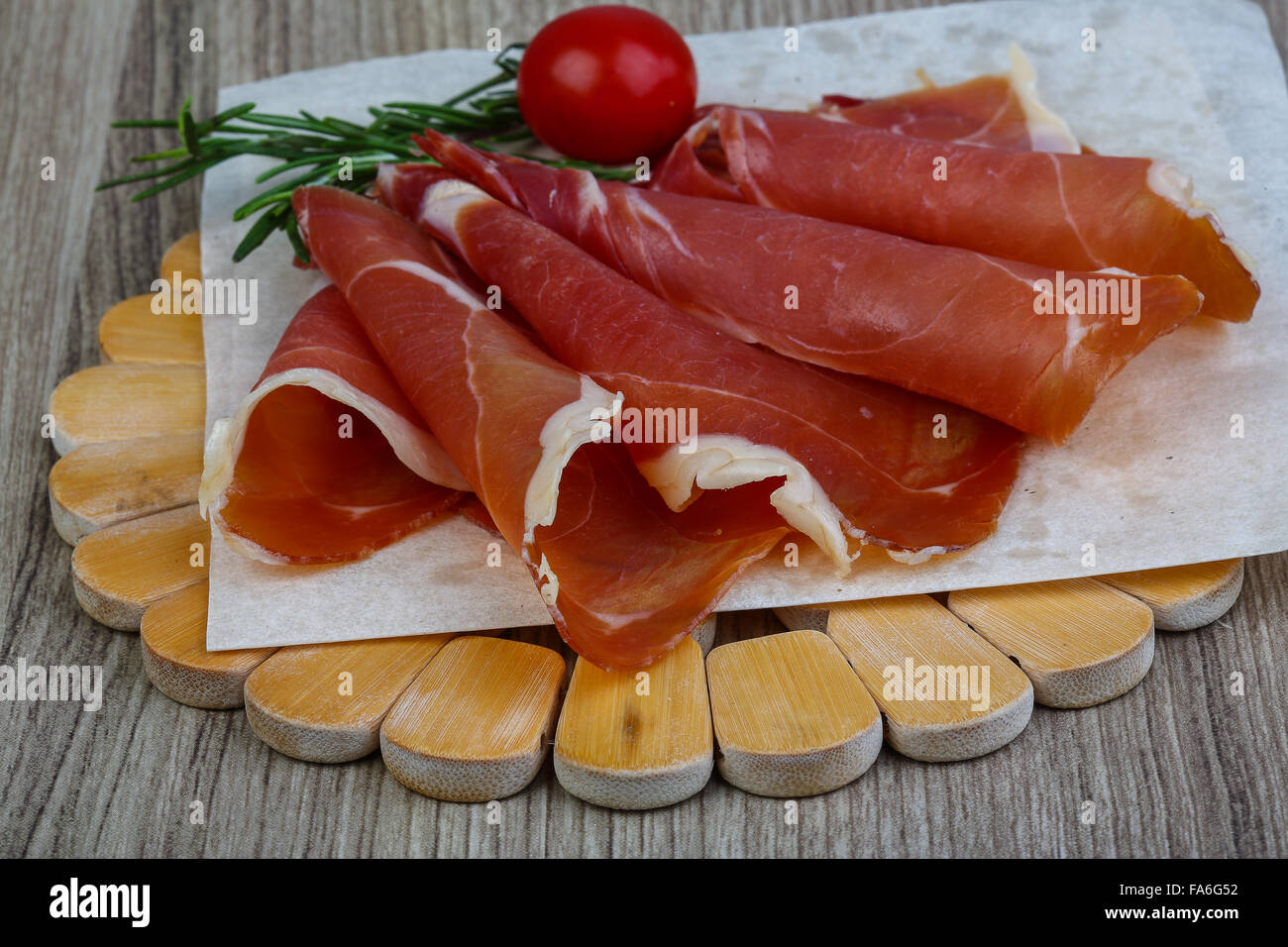 Spanish traditional snack - Jamon with tomato and rosemary Stock Photo ...
