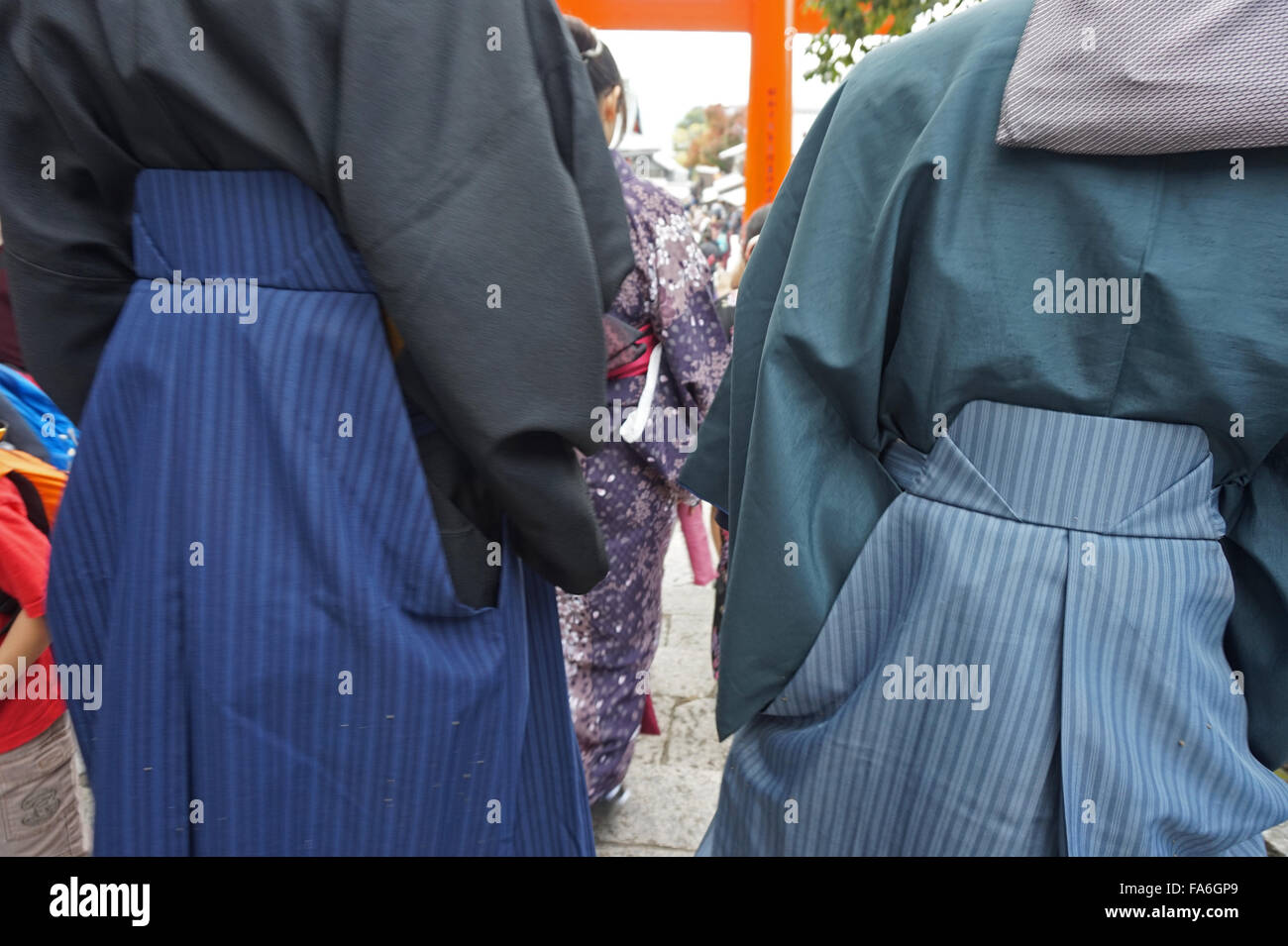 Tourists wearing rented traditional dress at a temple in Kyoto, Japan ...