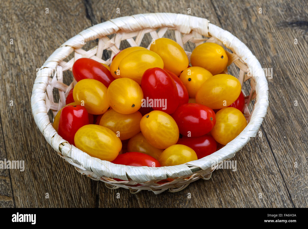 Yellow and red cherry tomatoes mix on the basket Stock Photo - Alamy