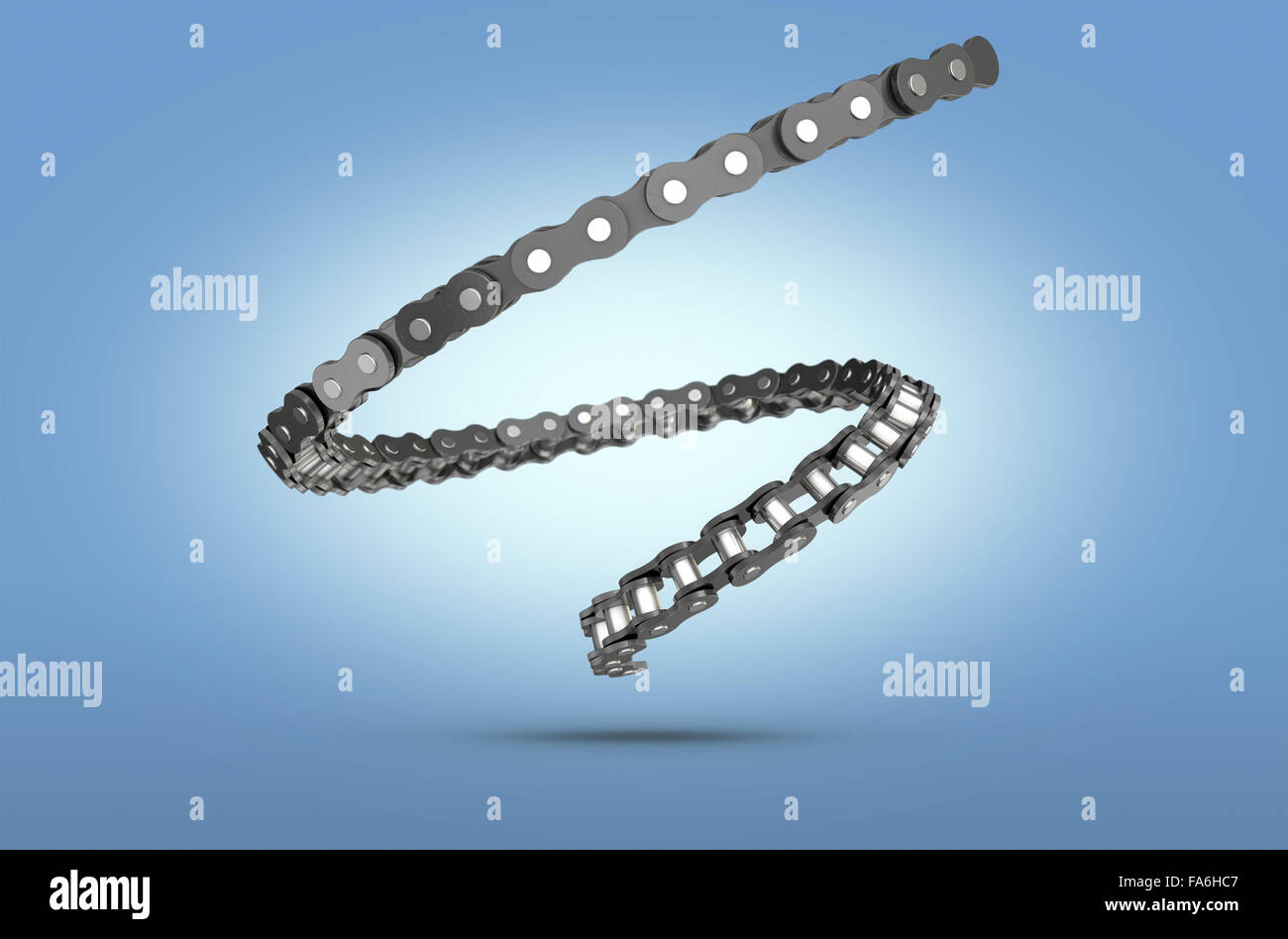 A section of a metal bicycle chain in the shape of a spiral on an ...