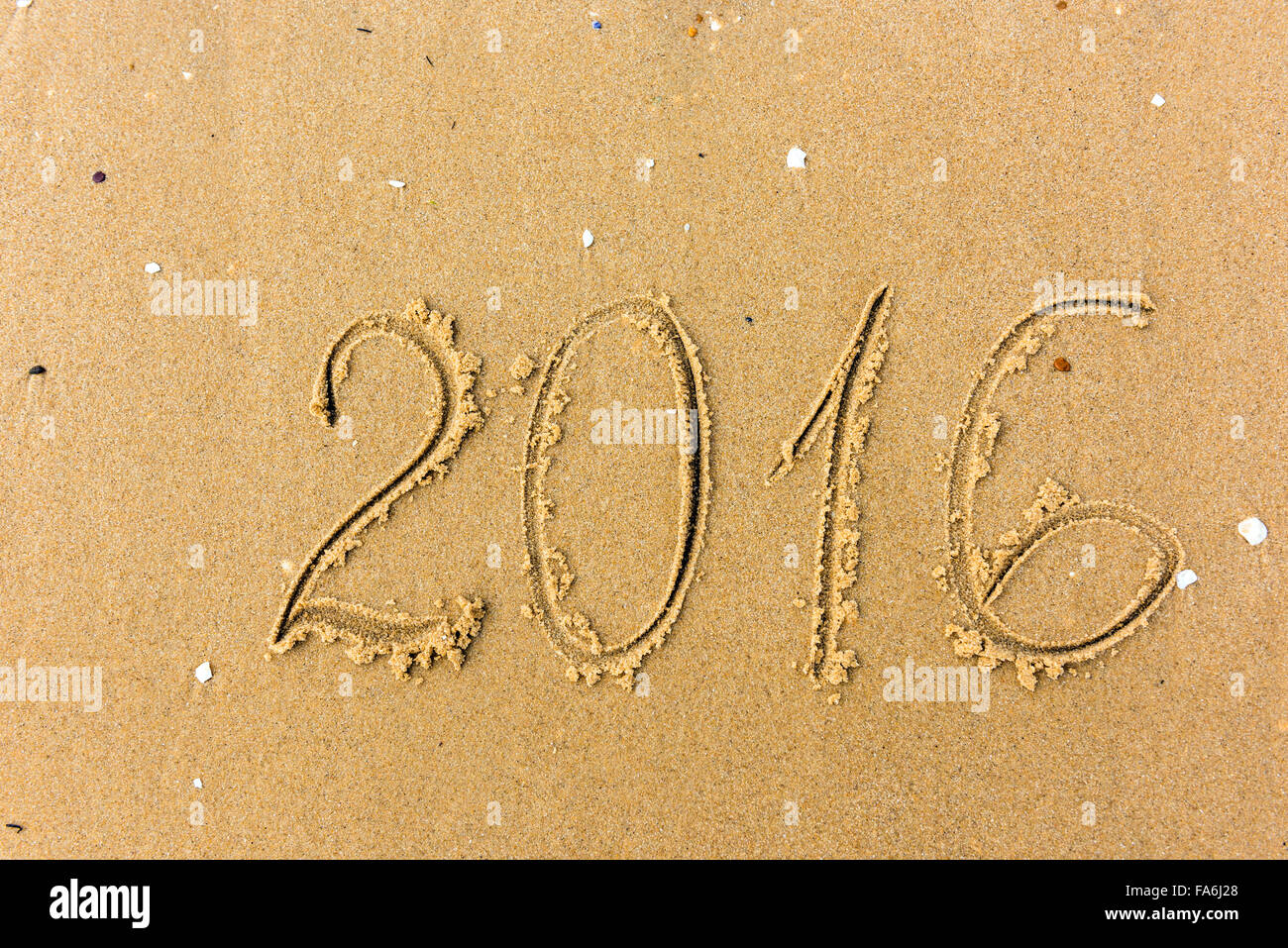 2016 Year written on the beach. sand background Stock Photo - Alamy