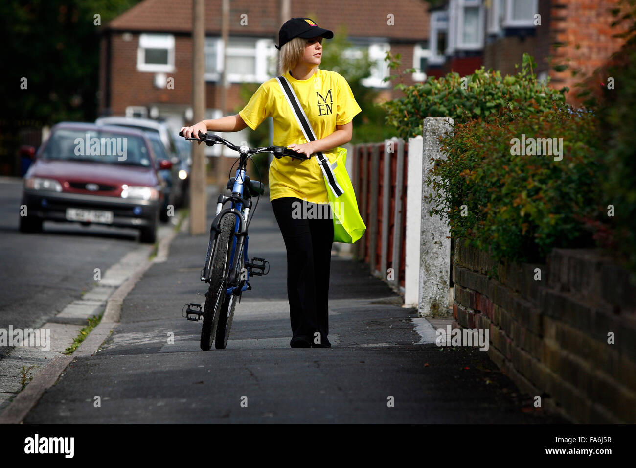 A papergirl on a newspaper round Stock Photo - Alamy