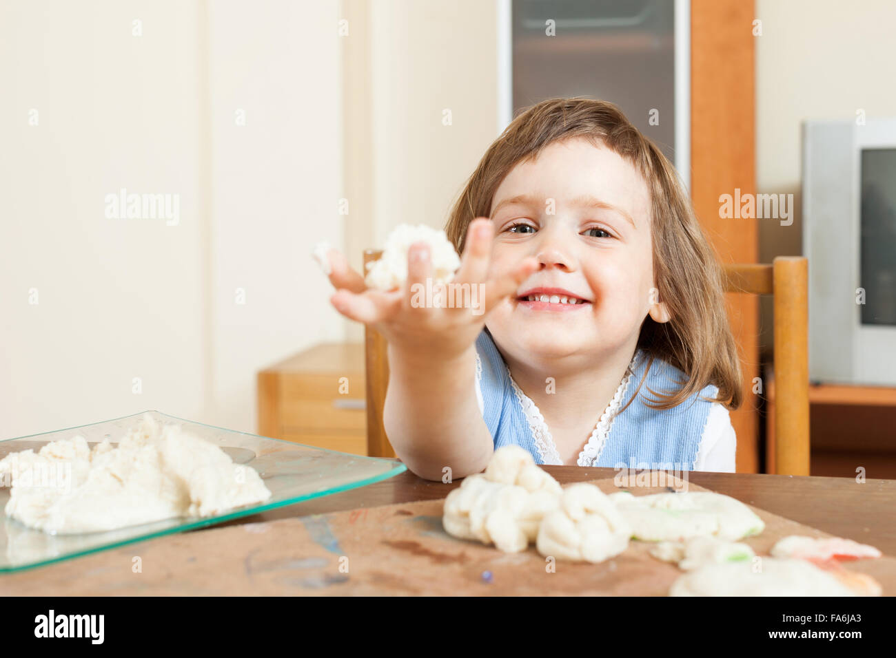 Child sculpting from clay at table in home Stock Photo - Alamy
