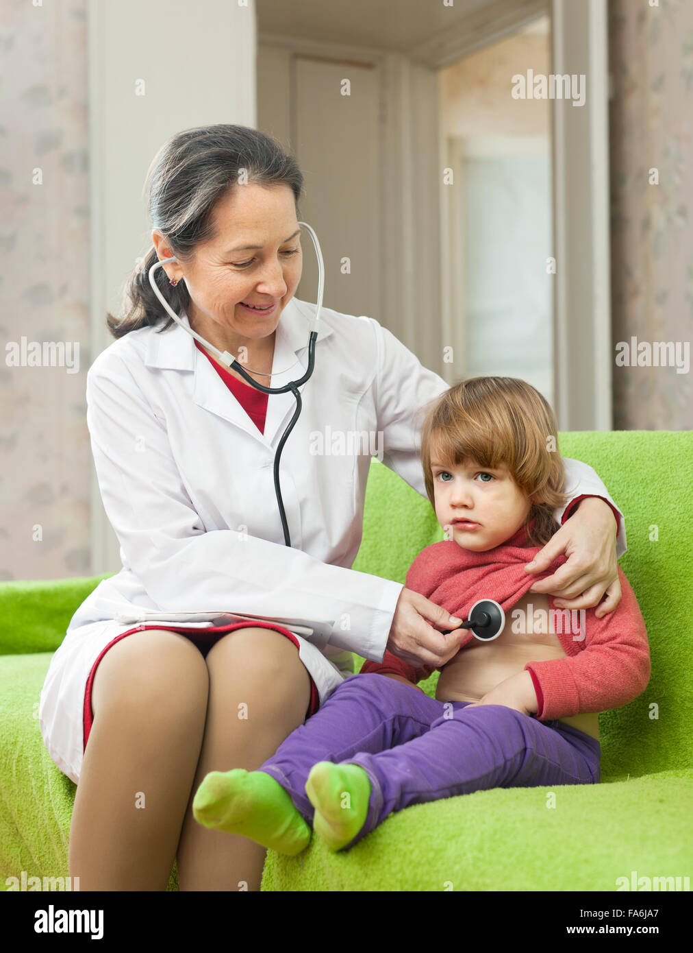 friendly pediatrician doctor examining 2 years baby with stethoscope ...