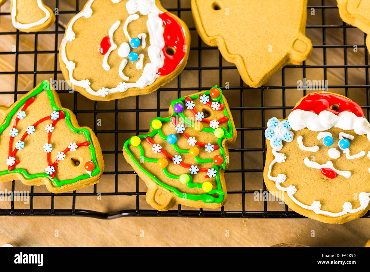 Decorating gingerbread cookies with royal icing and colorful candies ...