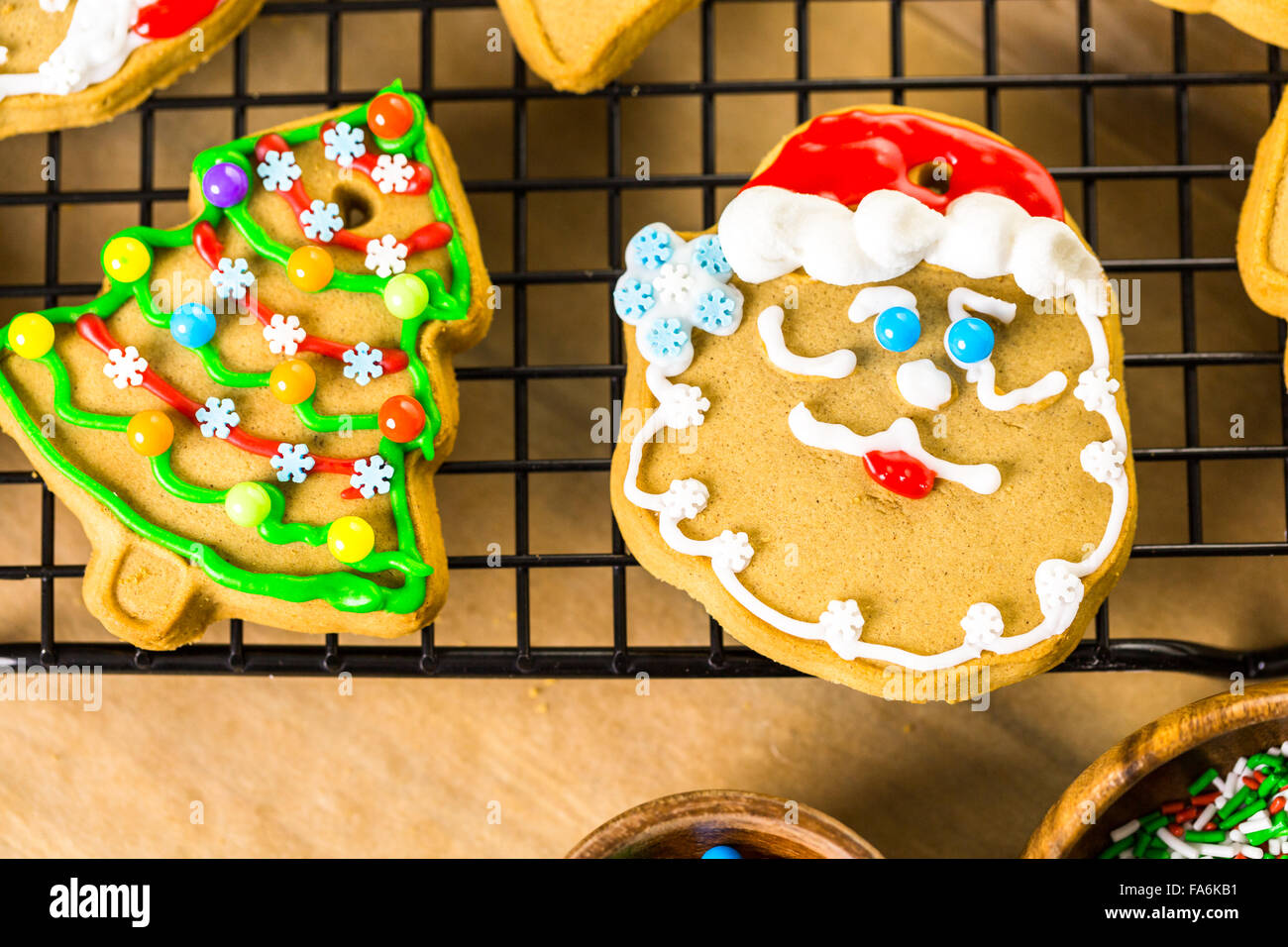 Decorating gingerbread cookies with royal icing and colorful candies ...