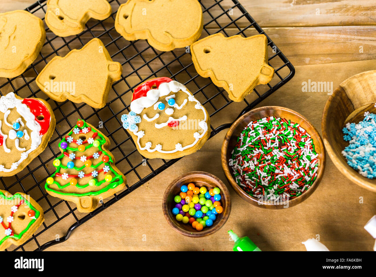 Decorating gingerbread cookies with royal icing and colorful candies ...