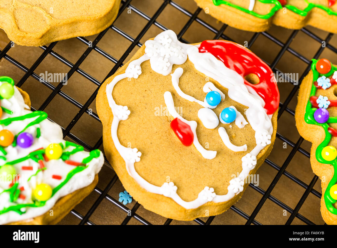 Decorating gingerbread cookies with royal icing and colorful candies ...