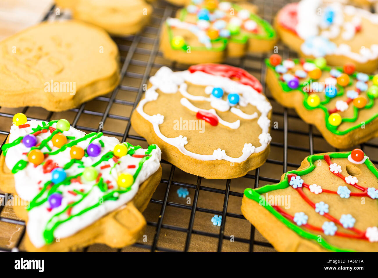 Decorating gingerbread cookies with royal icing and colorful candies ...