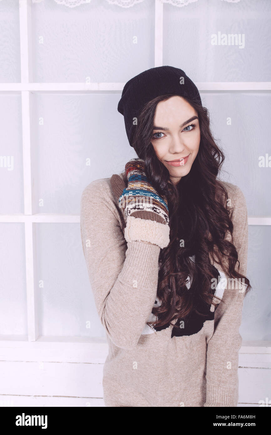Cute girl in winter outfit posing for the camera Stock Photo - Alamy